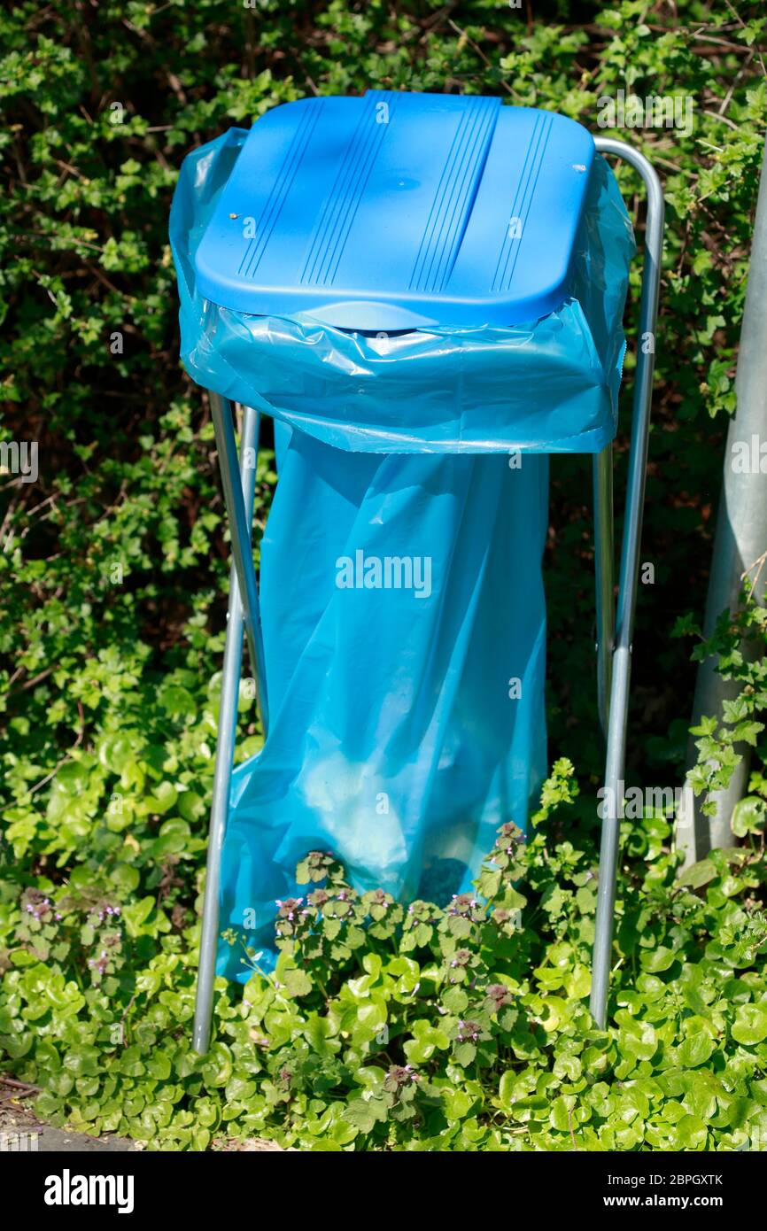 Public wastebasket, blue garbage bag, rack Stock Photo - Alamy