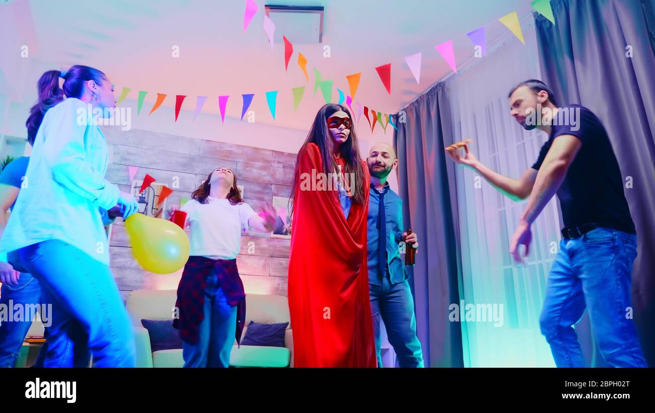 Attractive girl full of excitement wearing a superhero red cap while ...