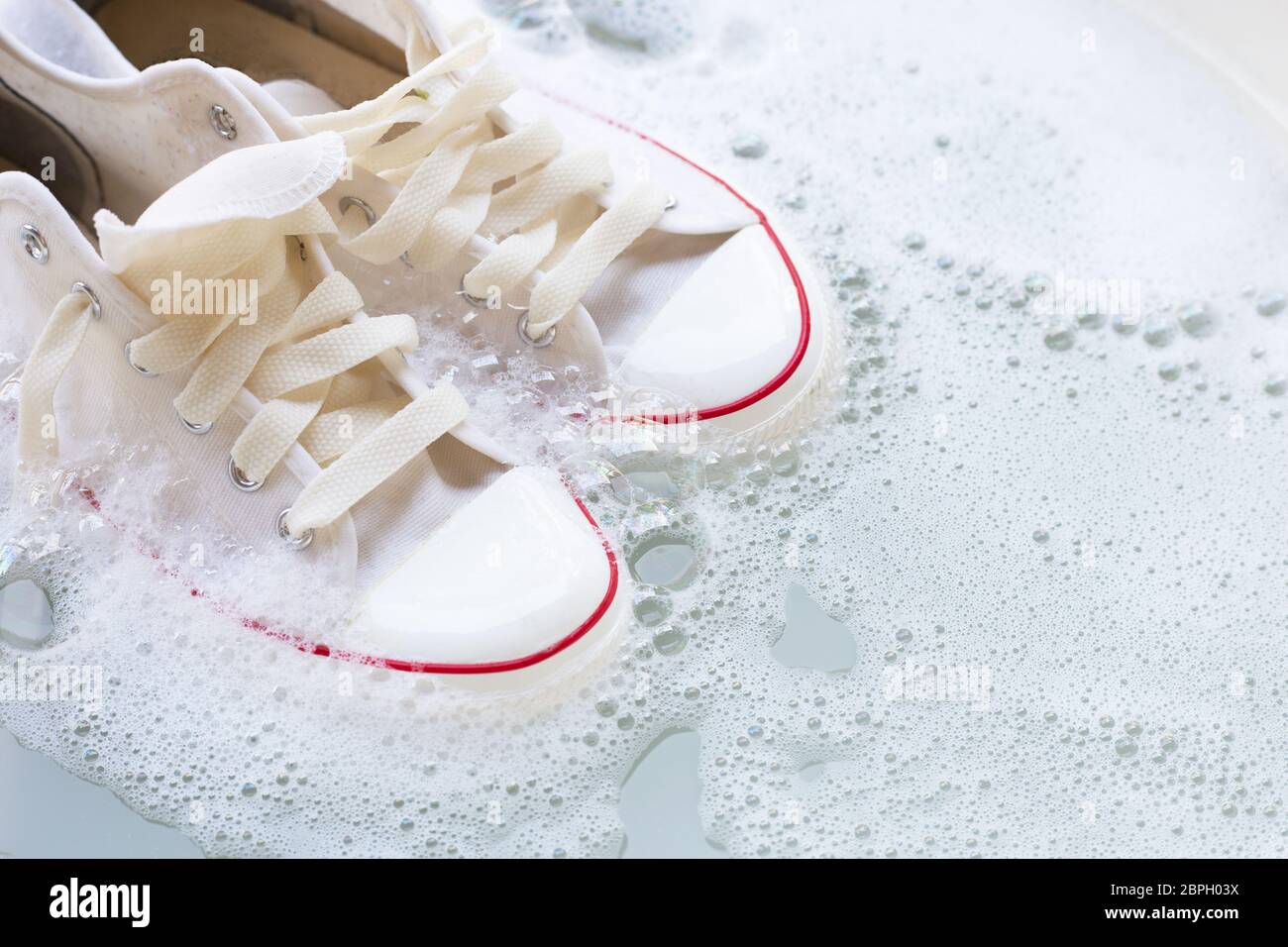 Soak shoes before washing. Cleaning Dirty sneakers Stock Photo - Alamy