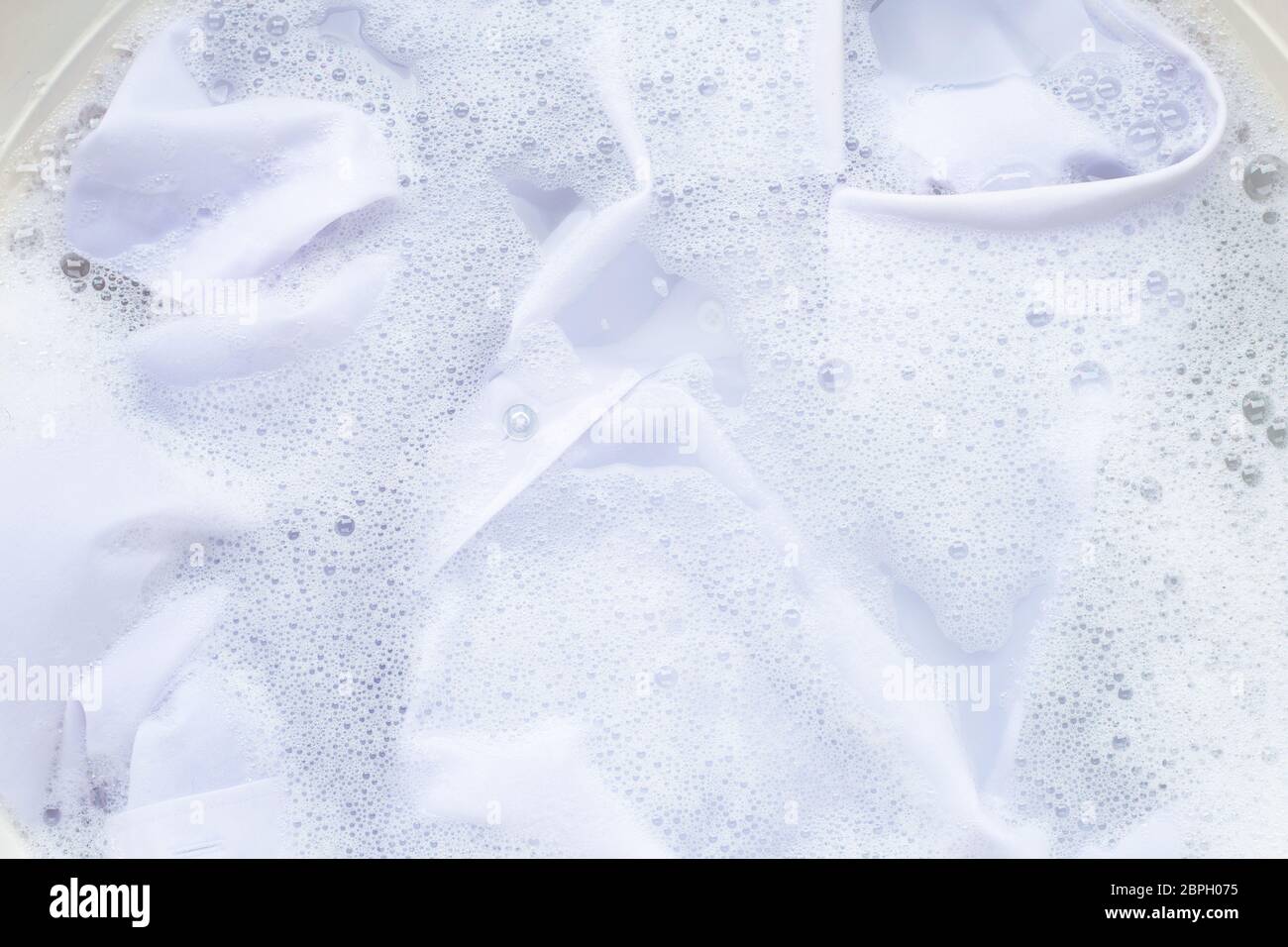Soak a cloth before washing, white shirt Stock Photo - Alamy