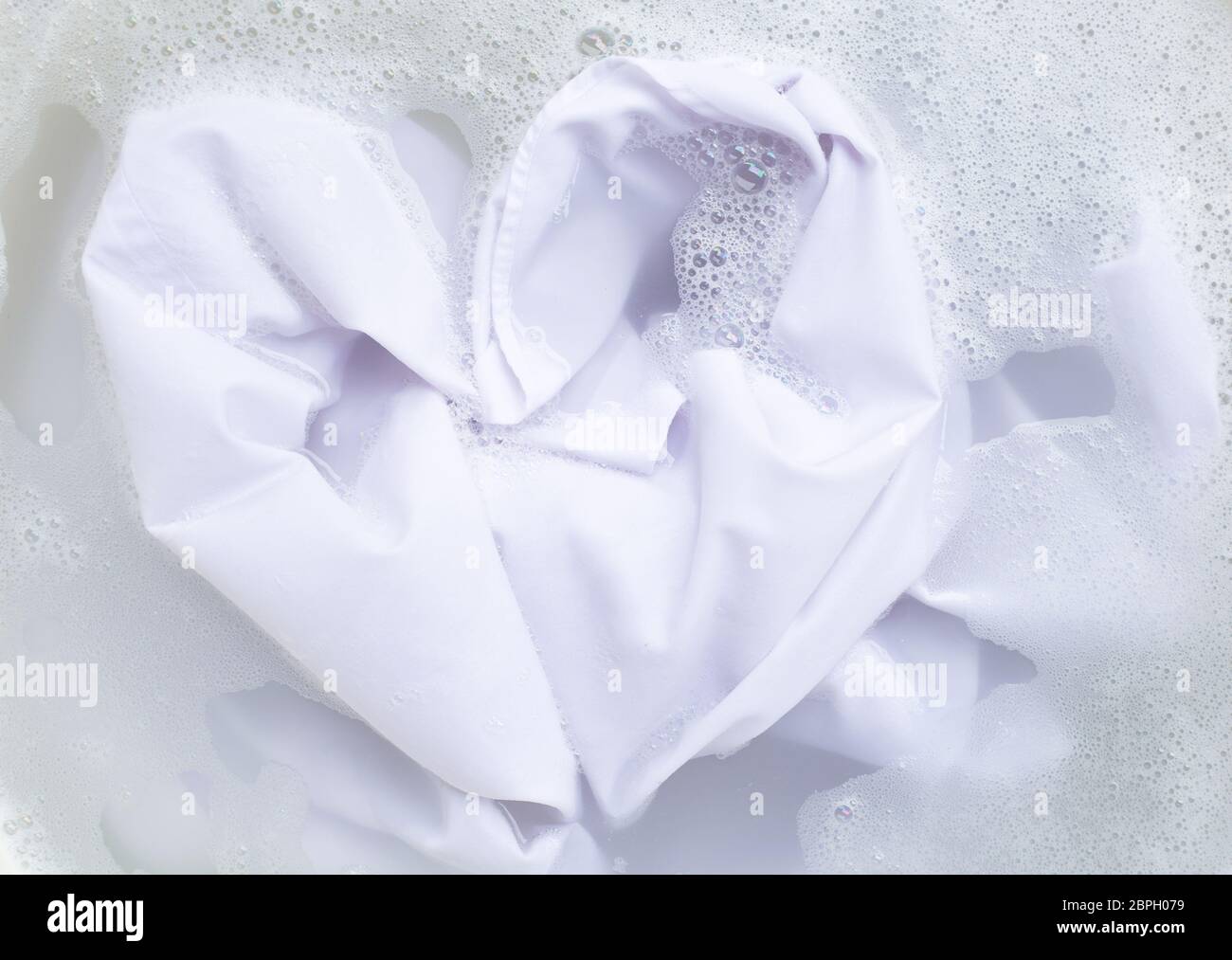 Soak a cloth before washing, white shirt Stock Photo - Alamy