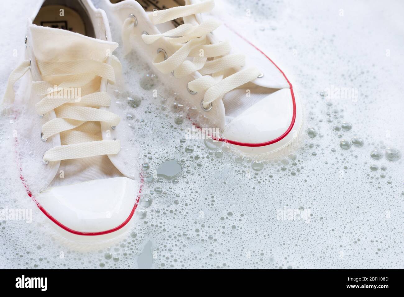 Soak shoes before washing. Cleaning Dirty sneakers Stock Photo - Alamy