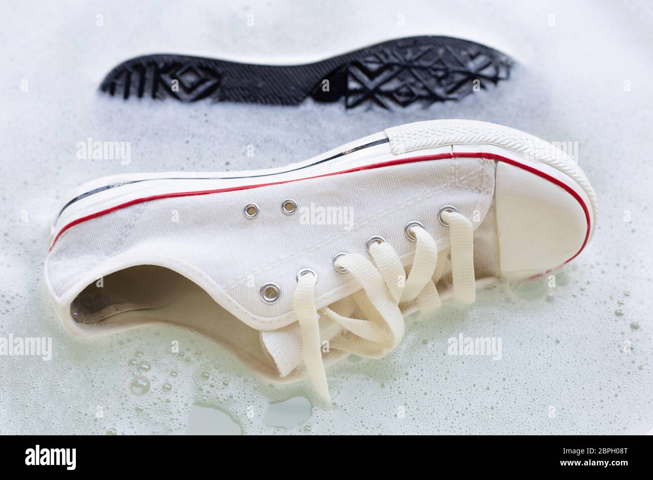 Soak shoes before washing. Cleaning Dirty sneakers Stock Photo - Alamy