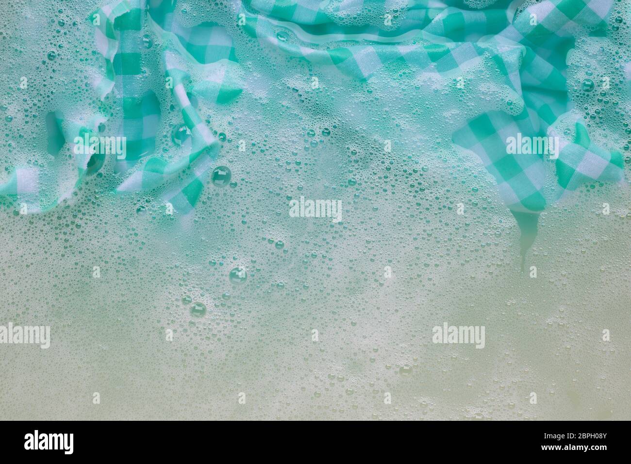 Soak a cloth before washing Stock Photo - Alamy