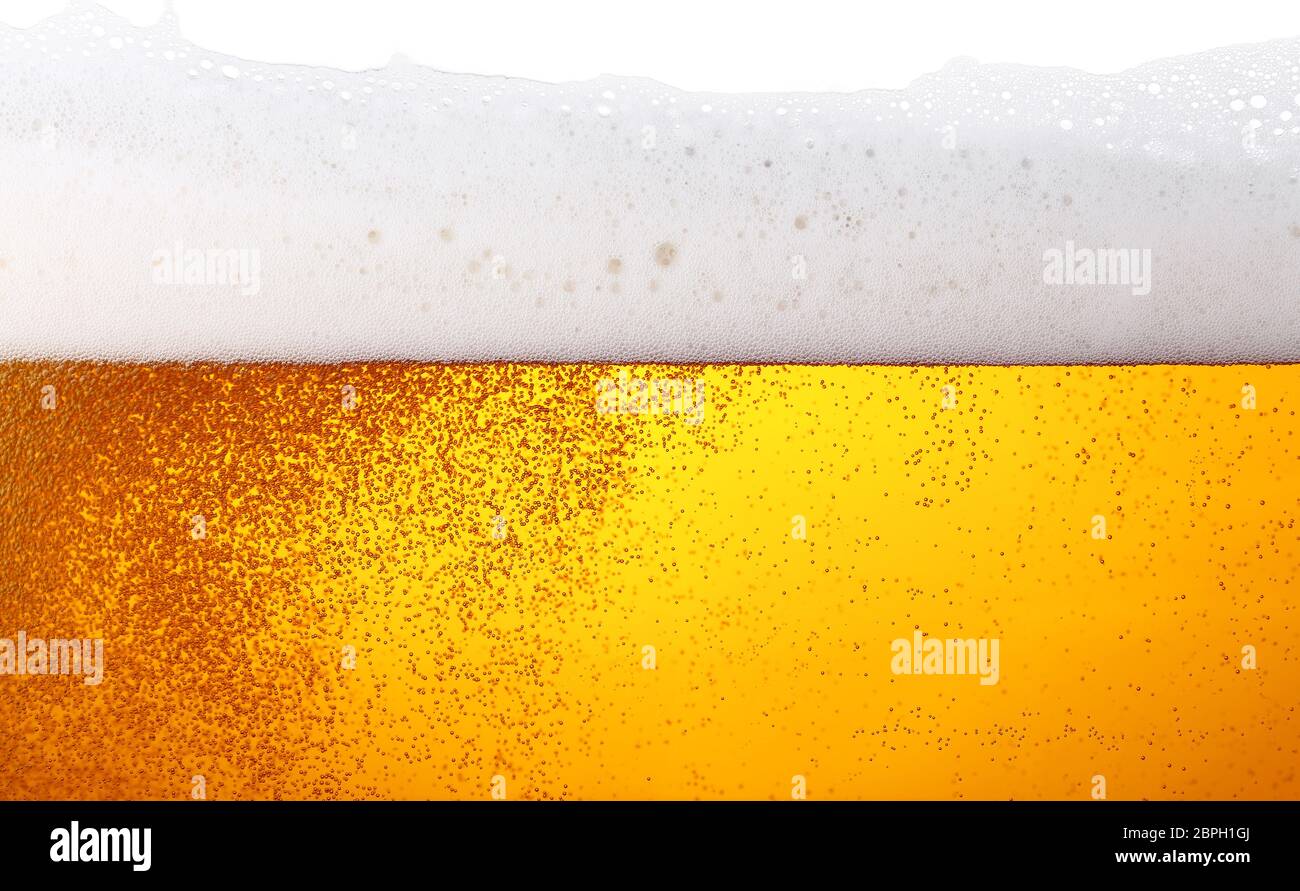 Close up background texture of lager beer with bubbles and froth in ...