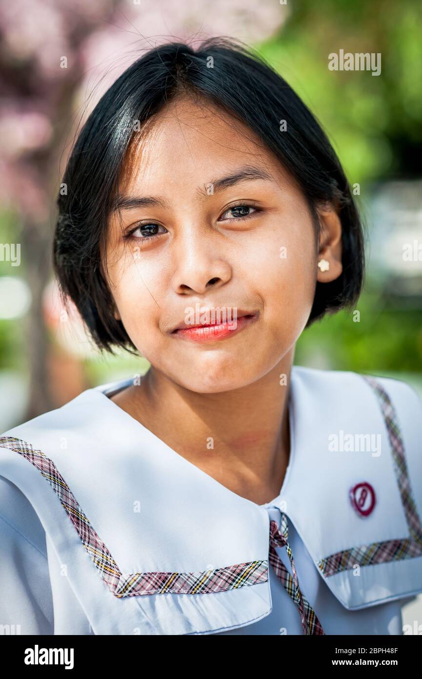A beautiful Filipino school girl poses in a park in Angeles City ...