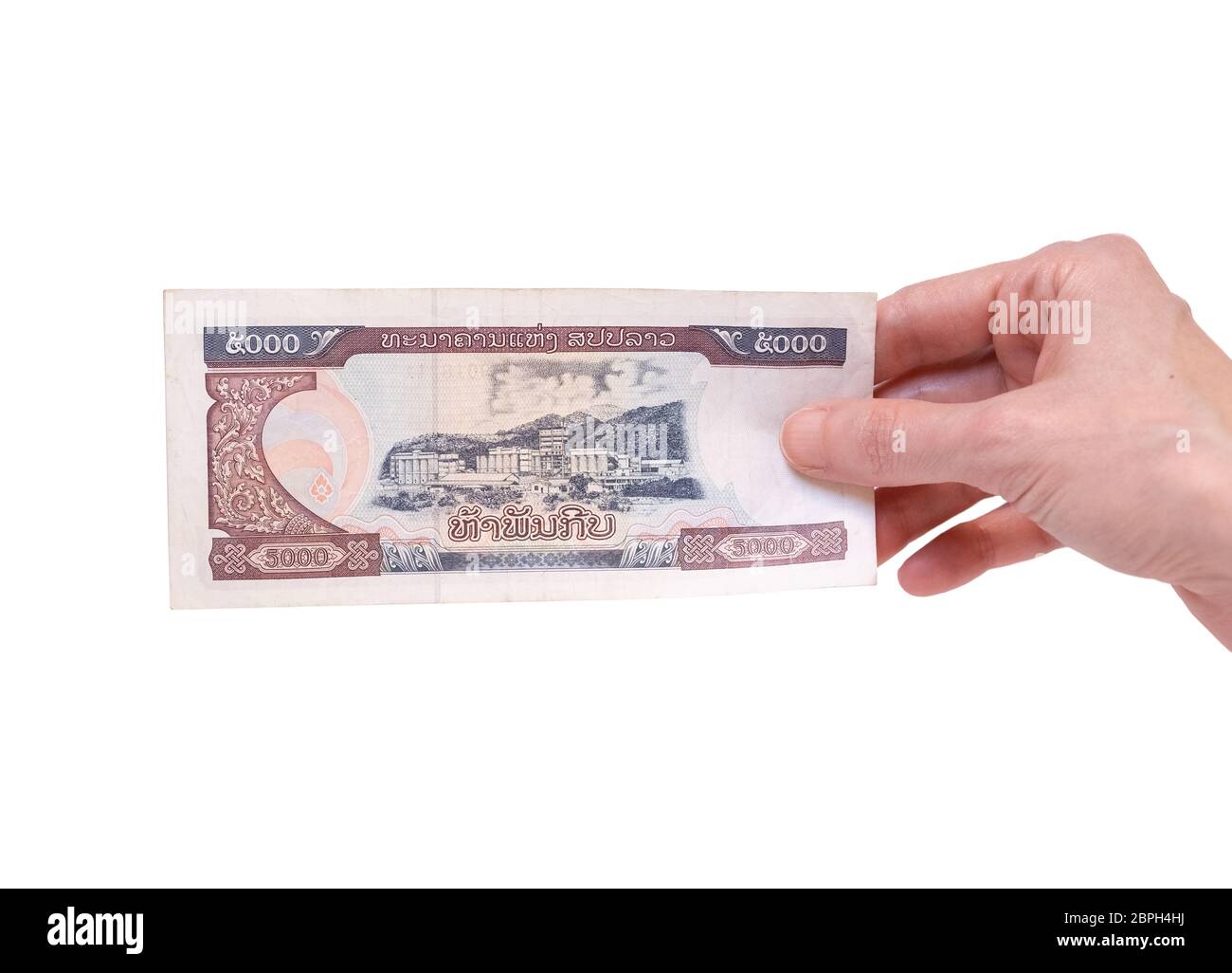 Female hand holding a 5000 Kip banknote currency isolated on a white ...