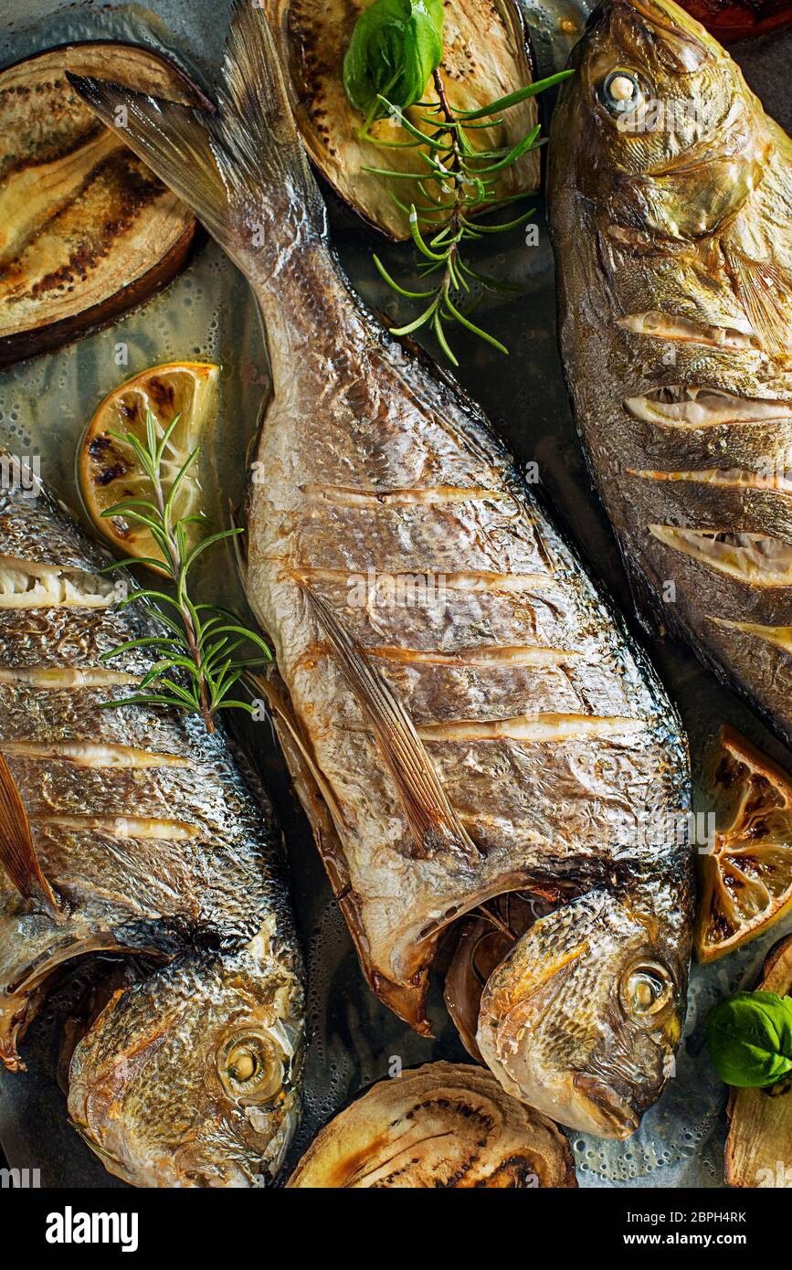 Grilled Gilt-head bream fish with vegetables and spices Stock Photo - Alamy