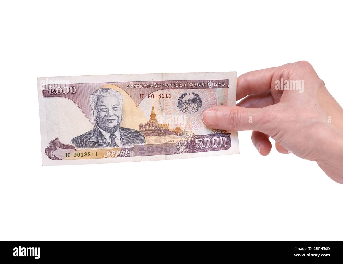 Female hand holding a 5000 Kip banknote currency isolated on a white ...