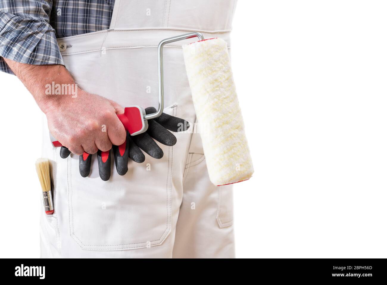House painter worker with white work overalls, keeps the roller to ...