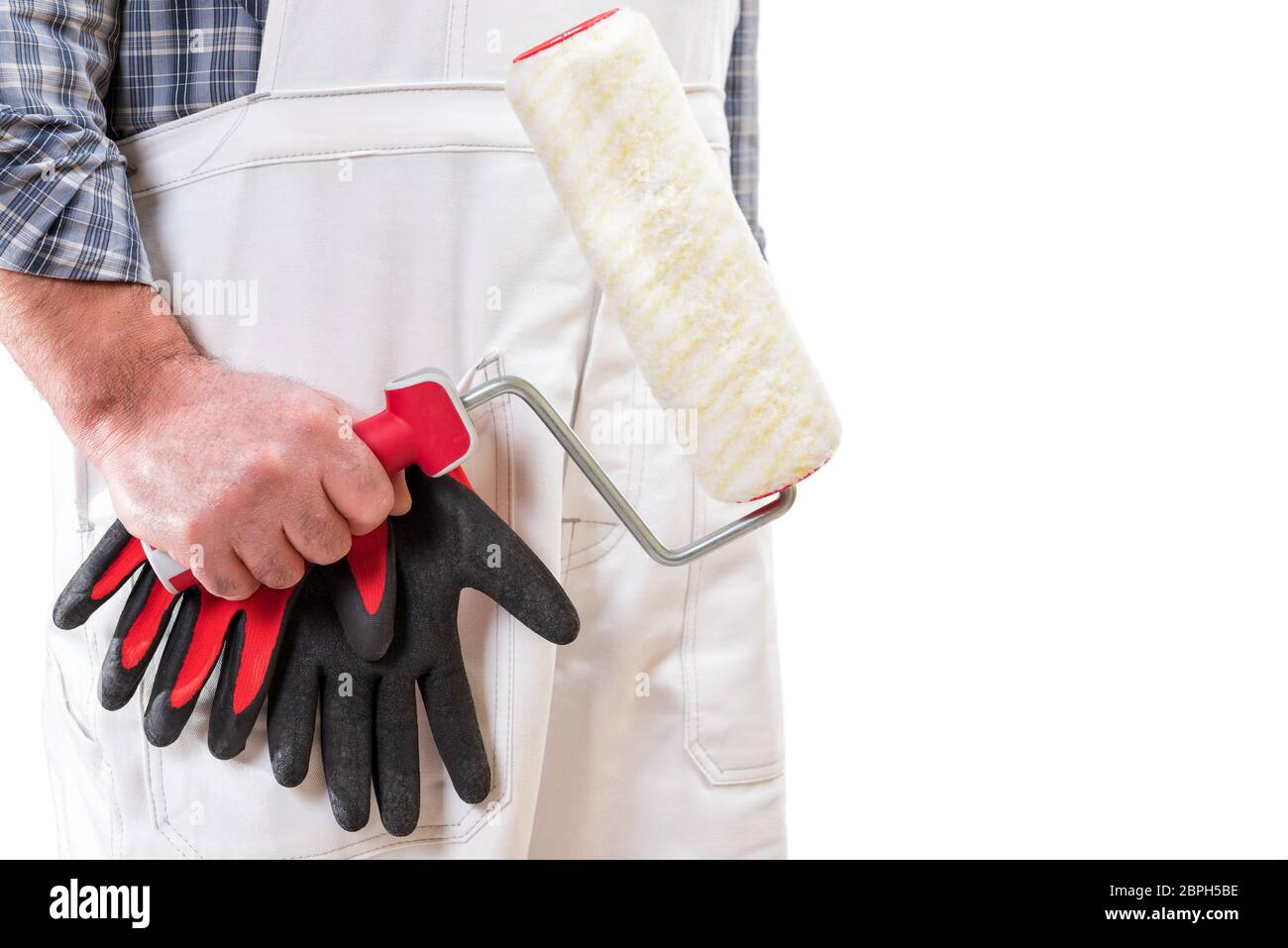 House painter worker with white work overalls, keeps the roller to ...