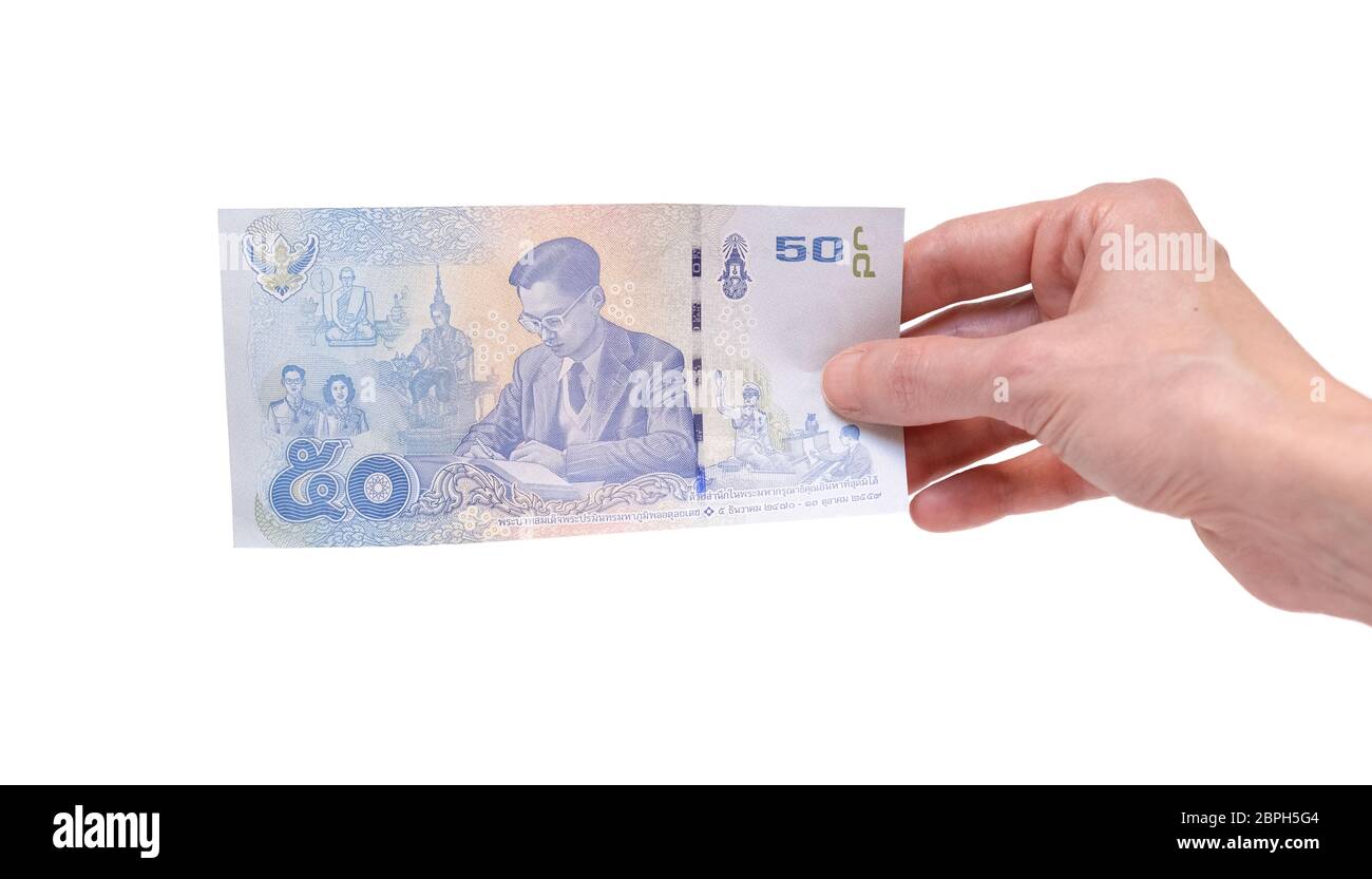 Female hand holding a 50 Thai Baht banknote isolated on a white ...