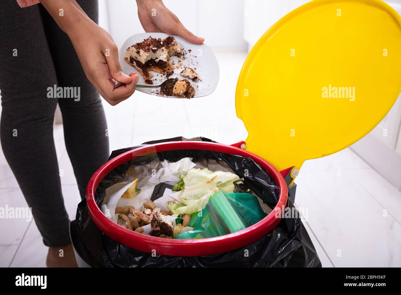Close-up Of A Woman's Hand Throwing Cake In Trash Bin Stock Photo - Alamy