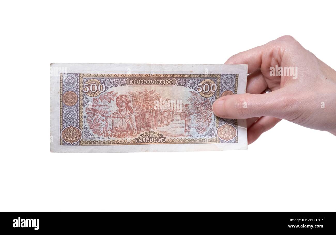 Female hand holding a 500 Kip 1988 banknote currency isolated on a ...
