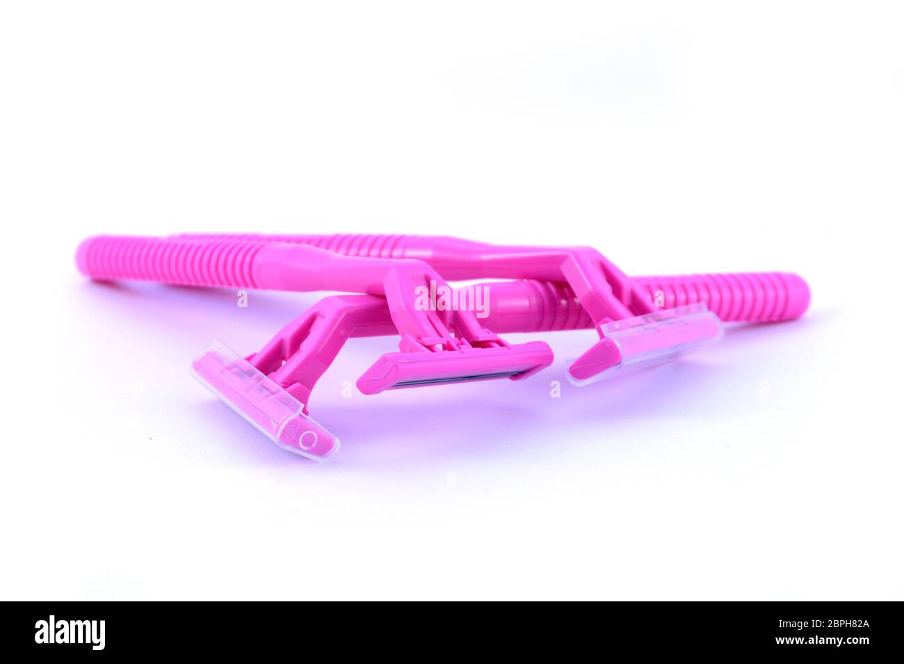 An isolated set of three new pink razors for womans hair removal Stock ...