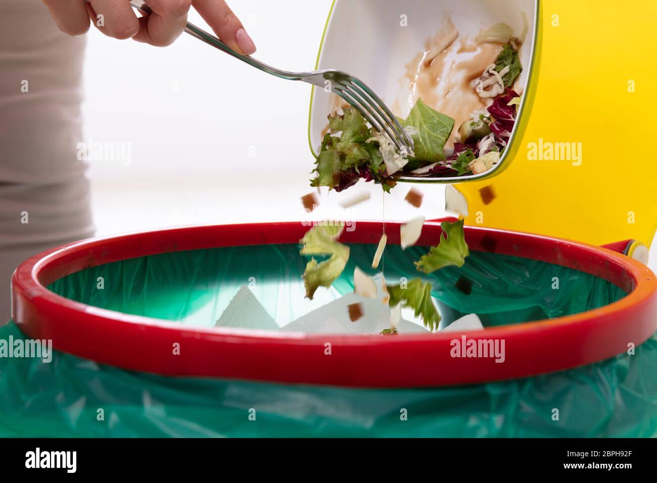 Woman throwing food in trash hi-res stock photography and images - Alamy