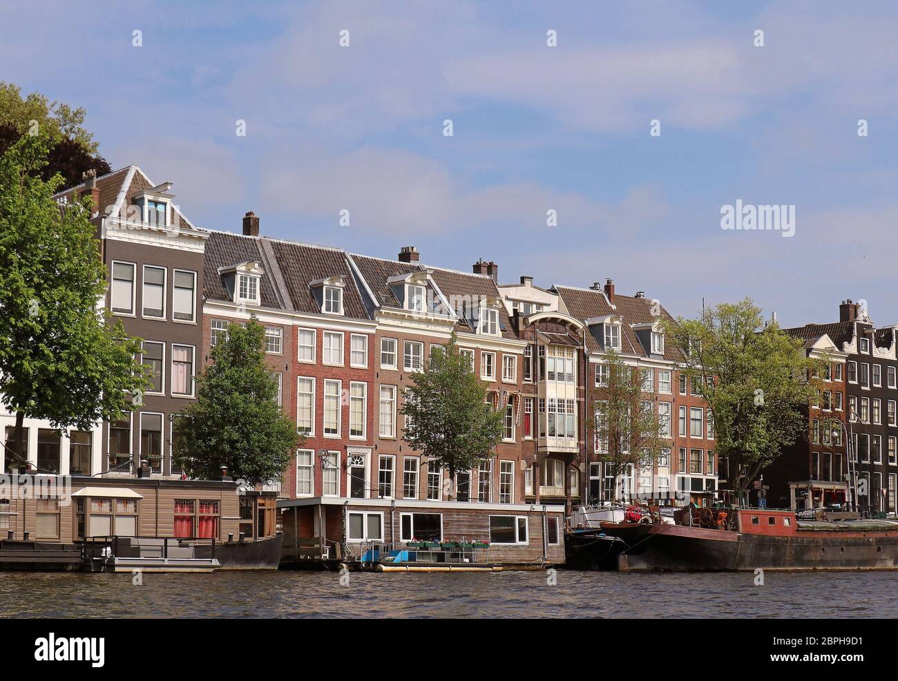 Traditional Dutch architecture houses on coast of Amstel river in ...