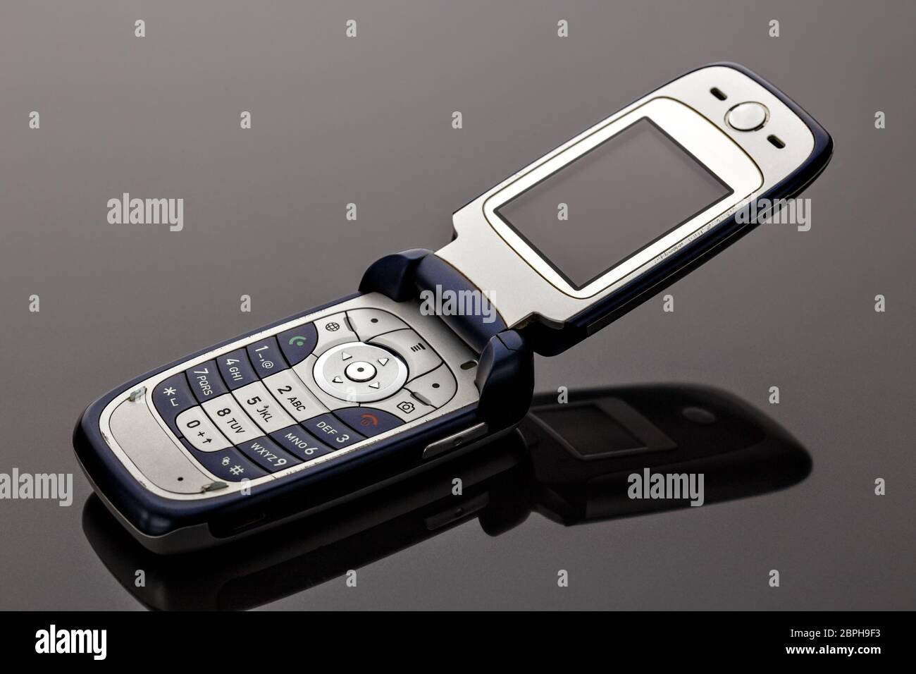 Old worn old-fashioned mobile phone on a gray background Stock Photo ...