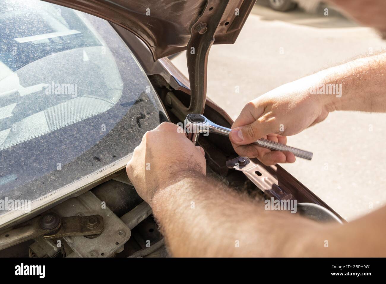 Auto mechanic works in the garage. Repair and removal of car windows ...