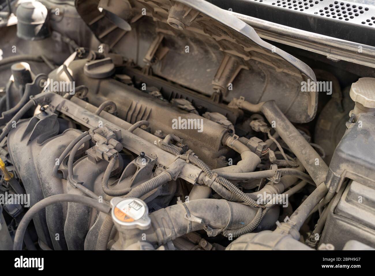 Auto mechanic works in the garage. Repair. Removing engine cover for ...