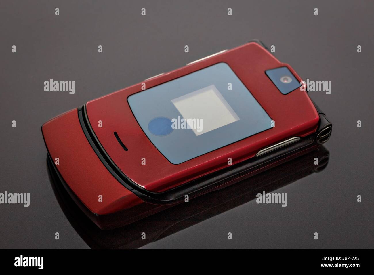 Old battered and scratched mobile phone on a gray background with ...