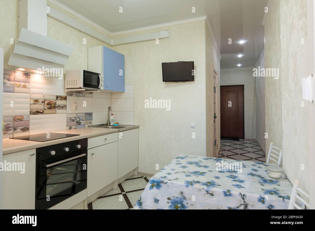 The interior of a small kitchen and corridor leading to the exit Stock ...