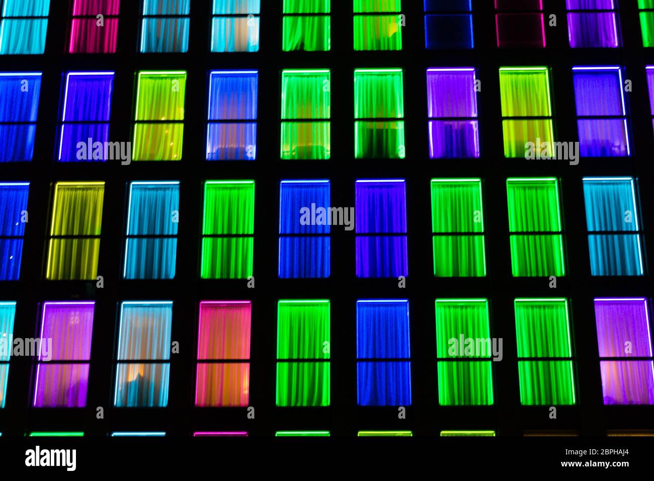 Colored windows texture. Windows illuminated by neon lights background ...