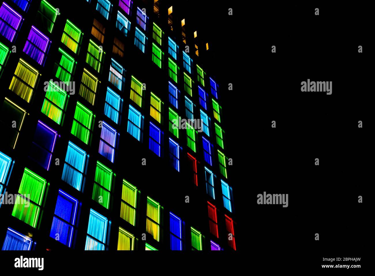 Colored windows texture. Windows illuminated by neon lights background ...