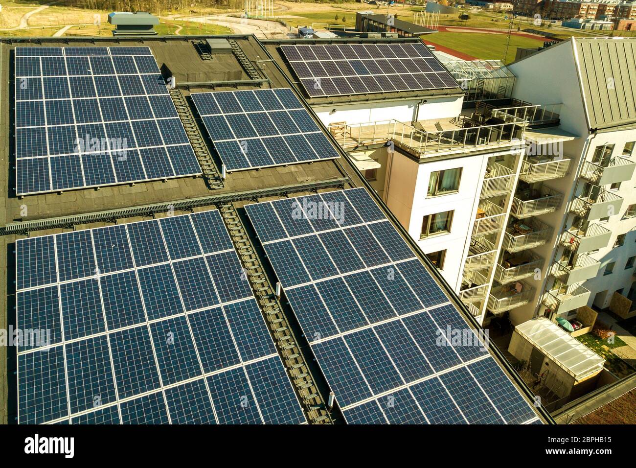 Aerial view of solar photovoltaic panels on a roof top of residential ...