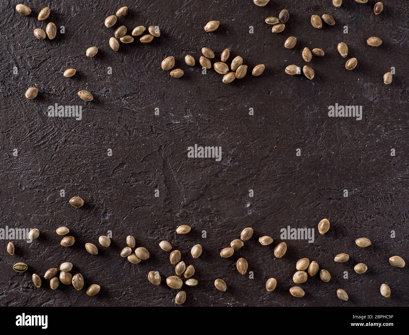 Hemp seeds top view. Unpeeled raw organic hemp seed on black background ...