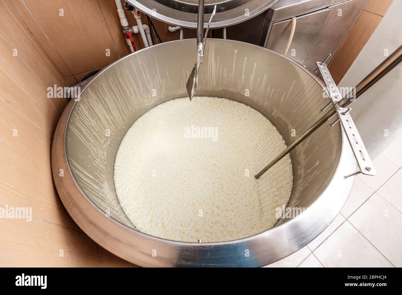 Cooking milk in a copper tank for cheese production Stock Photo - Alamy