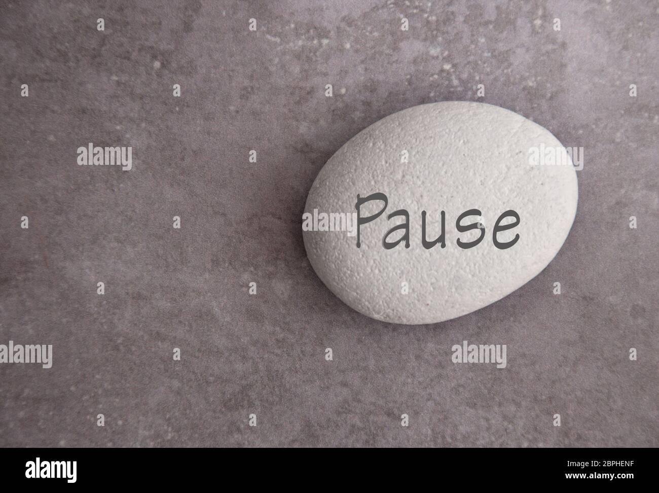 Pause handwritten on a yoga zen stone Stock Photo - Alamy