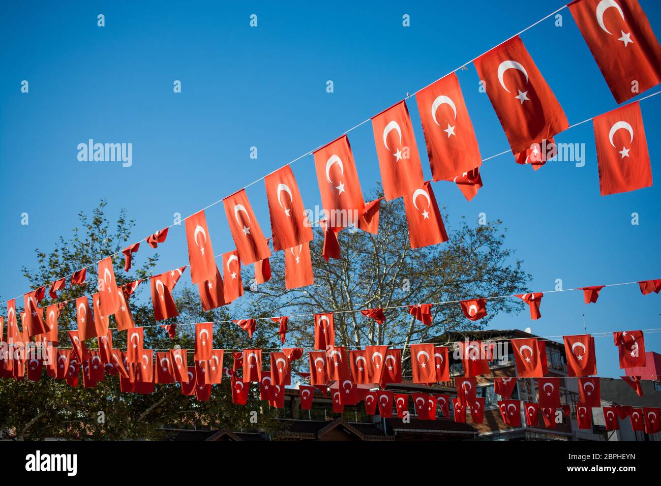 Turkish national flag hang on a pole on a rope in the street in open ...