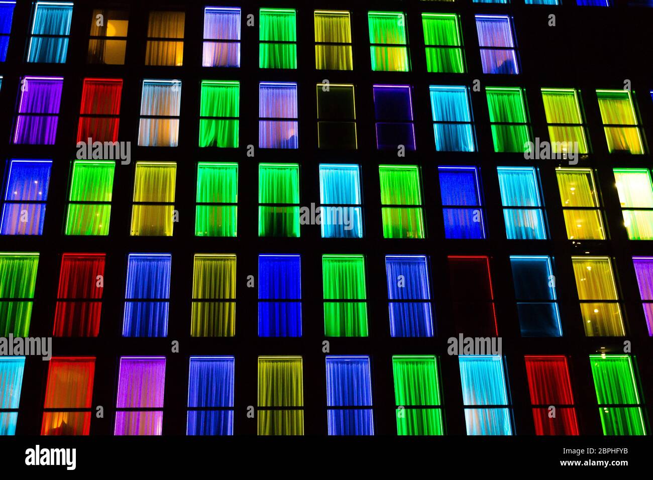 Colored windows texture. Windows illuminated by neon lights background ...