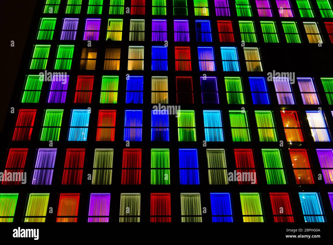 Colored windows texture. Windows illuminated by neon lights background ...