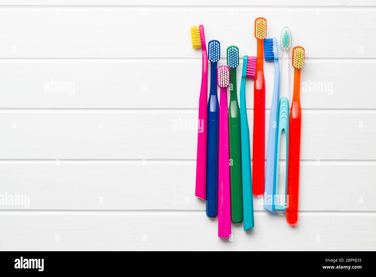 Colorful toothbrushes on white table Stock Photo - Alamy