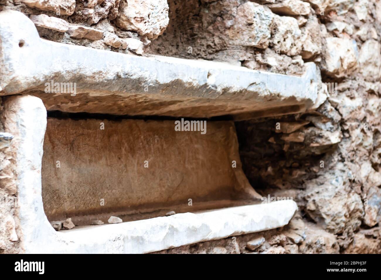 side view of interesting antique stone storage or furnace. photo has ...