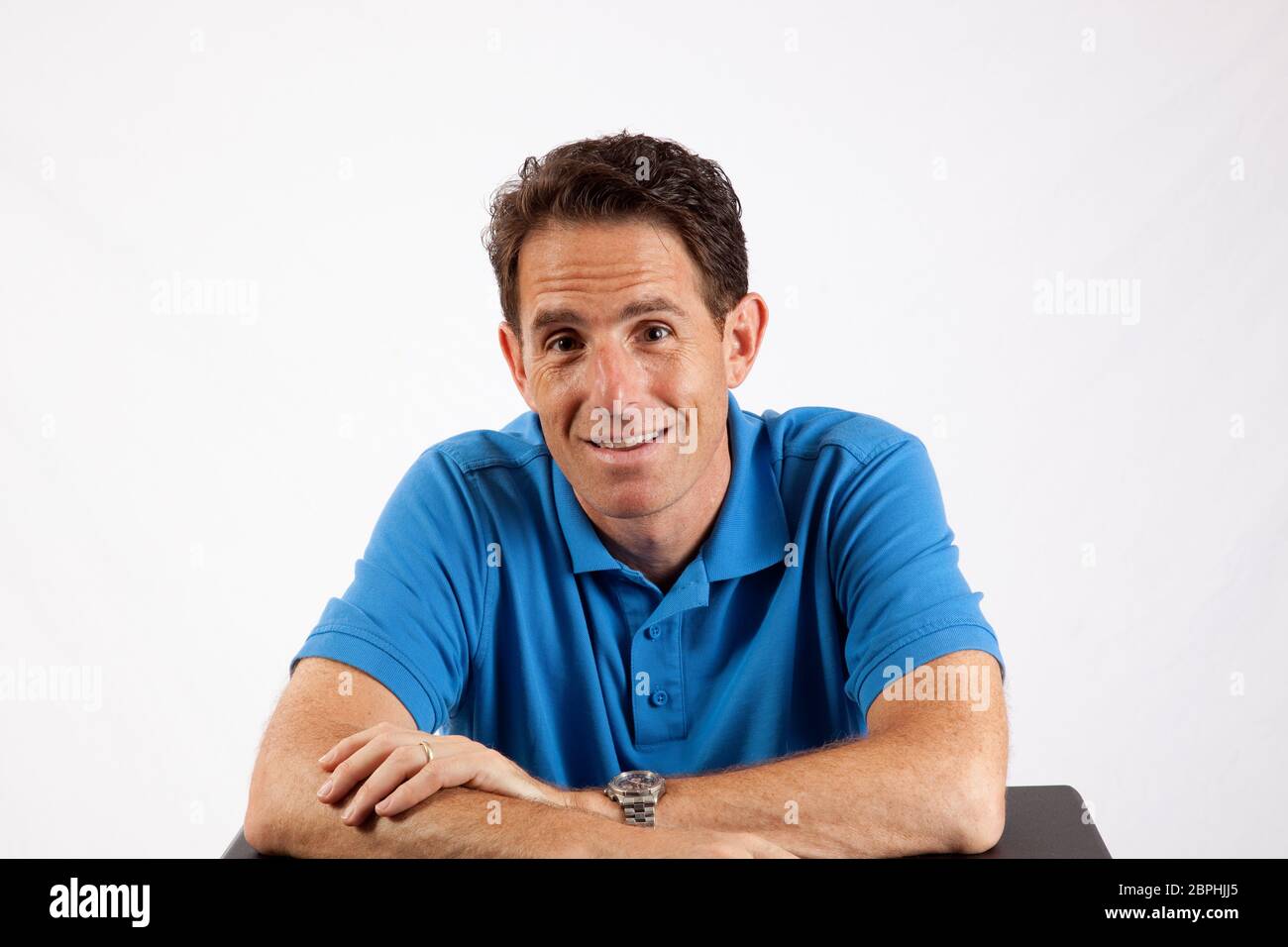 Happy man in a blue shirt with a smile Stock Photo - Alamy