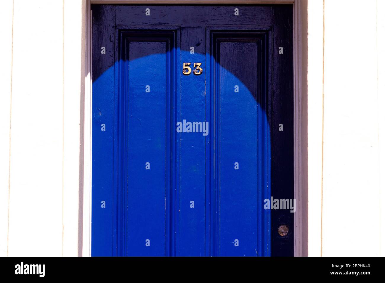 House number 53 on a royal blue wooden front door with vertical lines ...