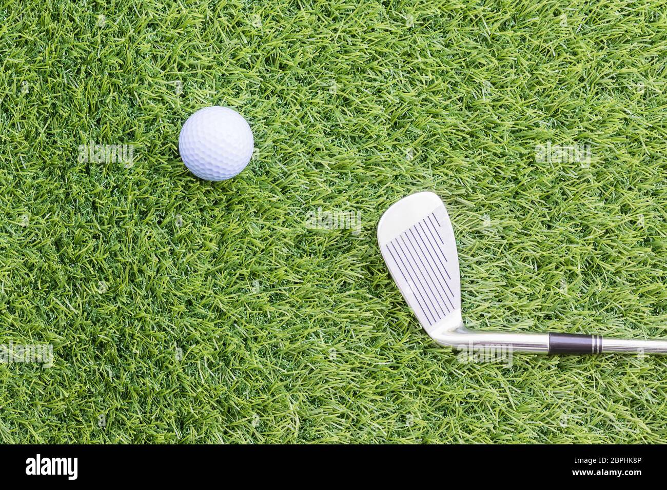 Sport objects related to golf equipment ,Golf club and ball on green ...
