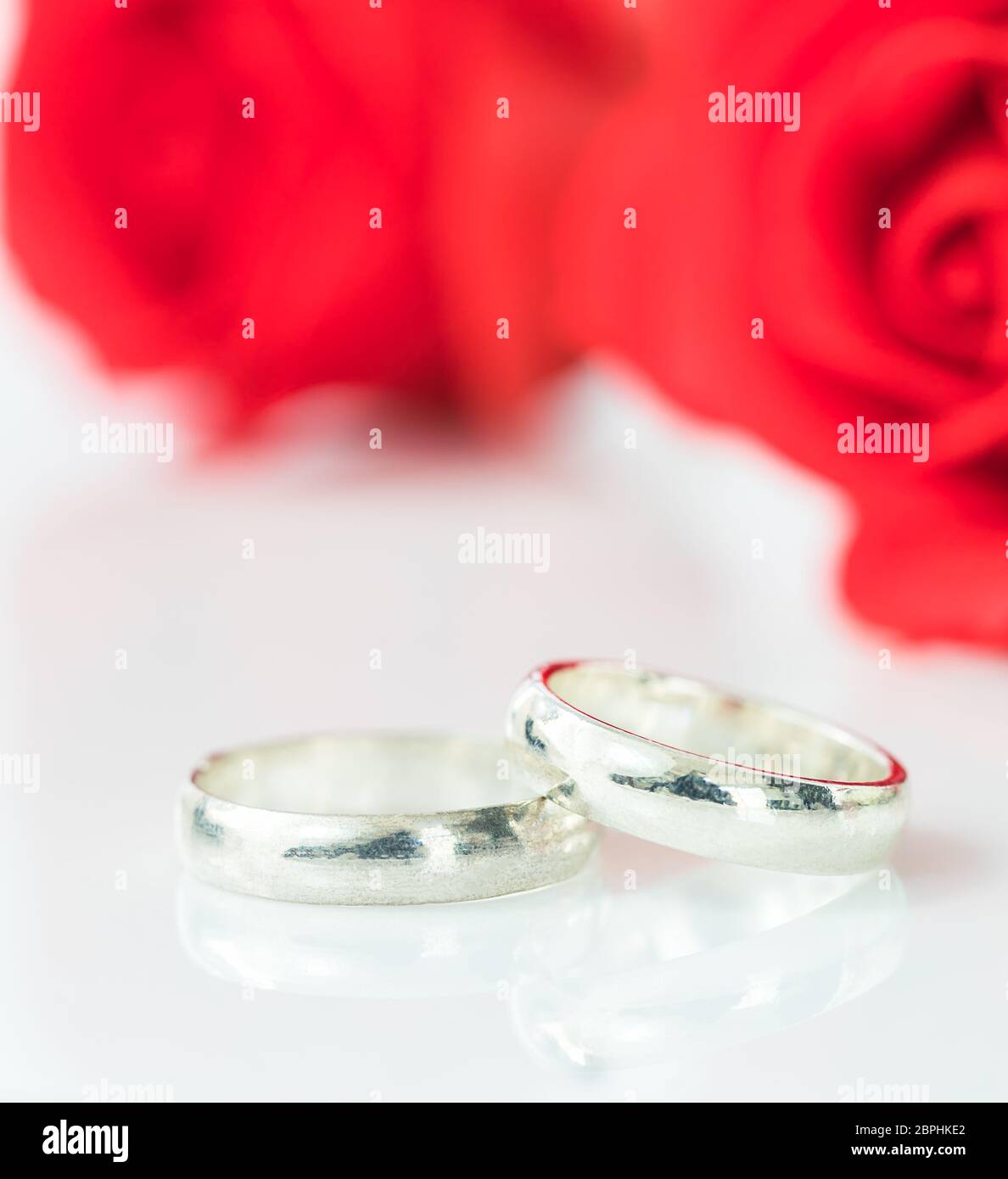 Close up red rose and wedding ring on white background, Wedding concept ...