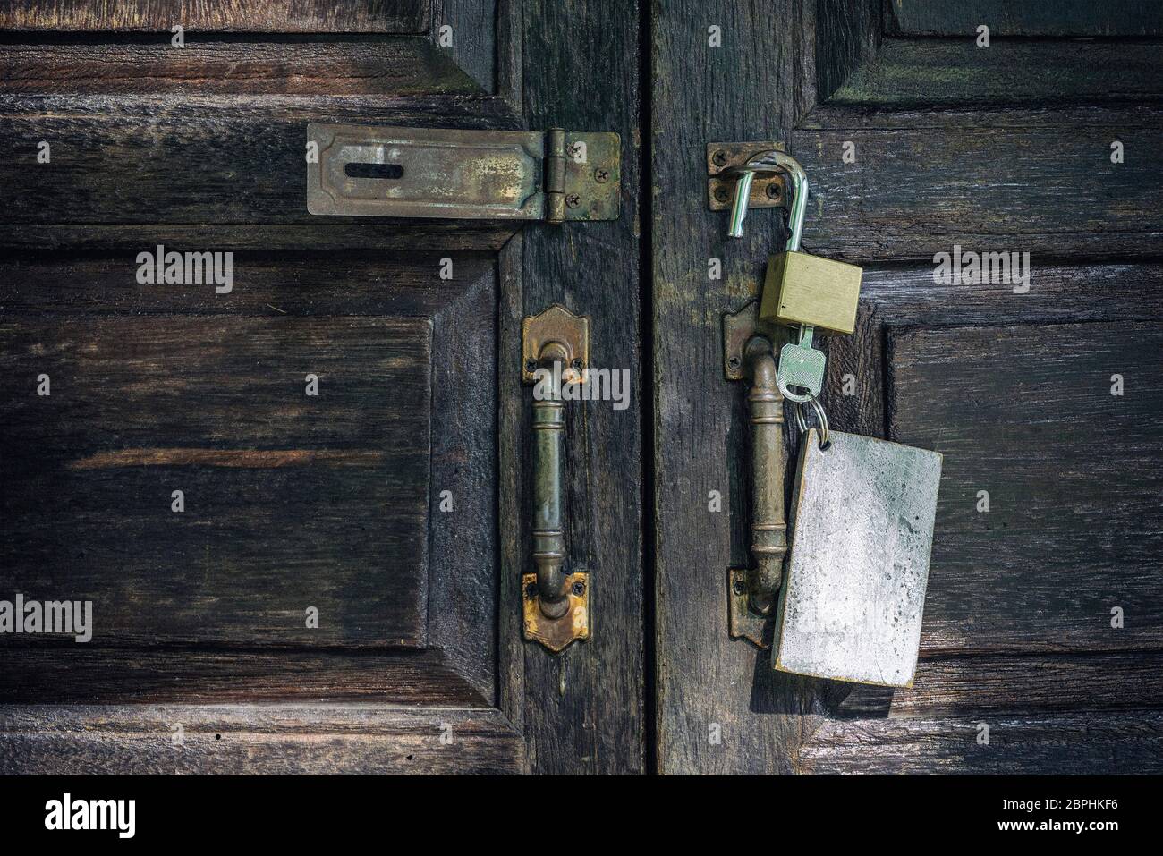 Old rusty and key locks on wooden door Stock Photo - Alamy