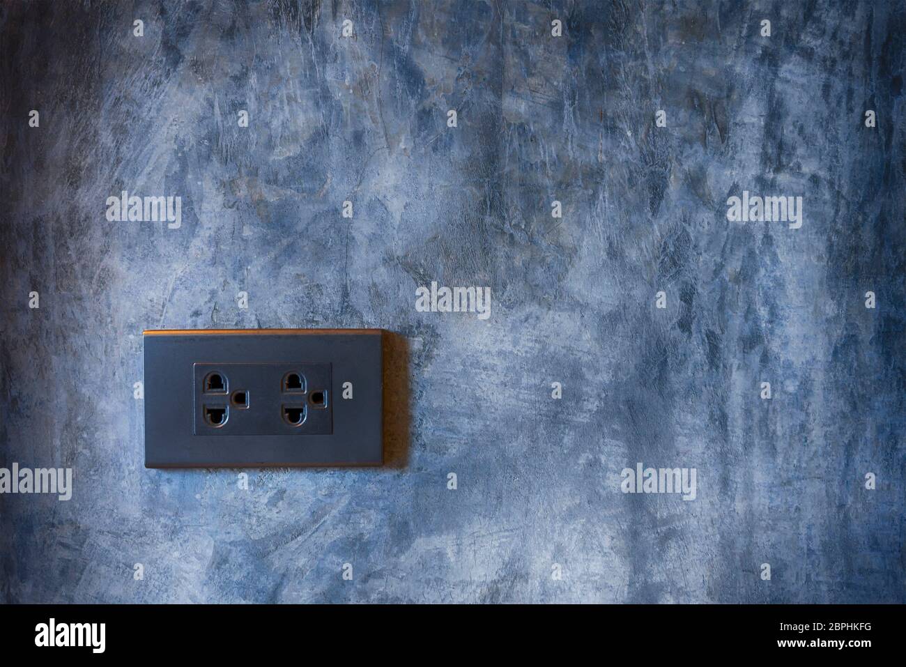 Black power outlet with cement wall background Stock Photo - Alamy