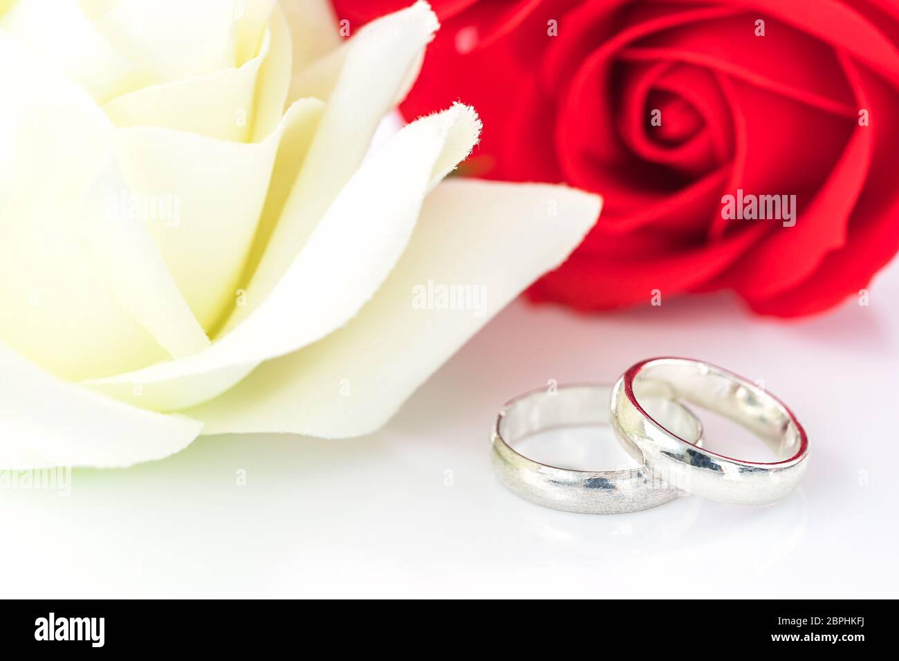 Close up red rose and wedding ring on white background, Wedding concept ...