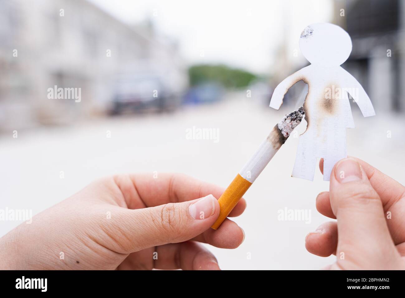 Paper cut of family members destroyed by cigarette. Smoking destroying ...