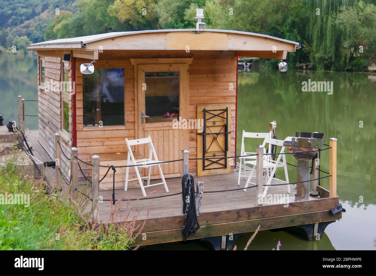 Wooden Houseboat on shore on river Lahn in Obernhof Germany Stock Photo ...