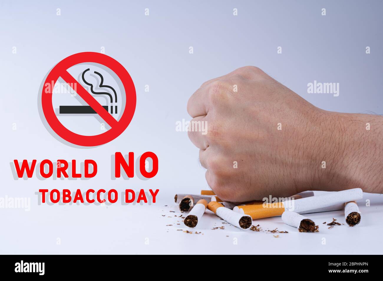 Stop smoking. Close up of male hand breaking cigarette with his fist ...