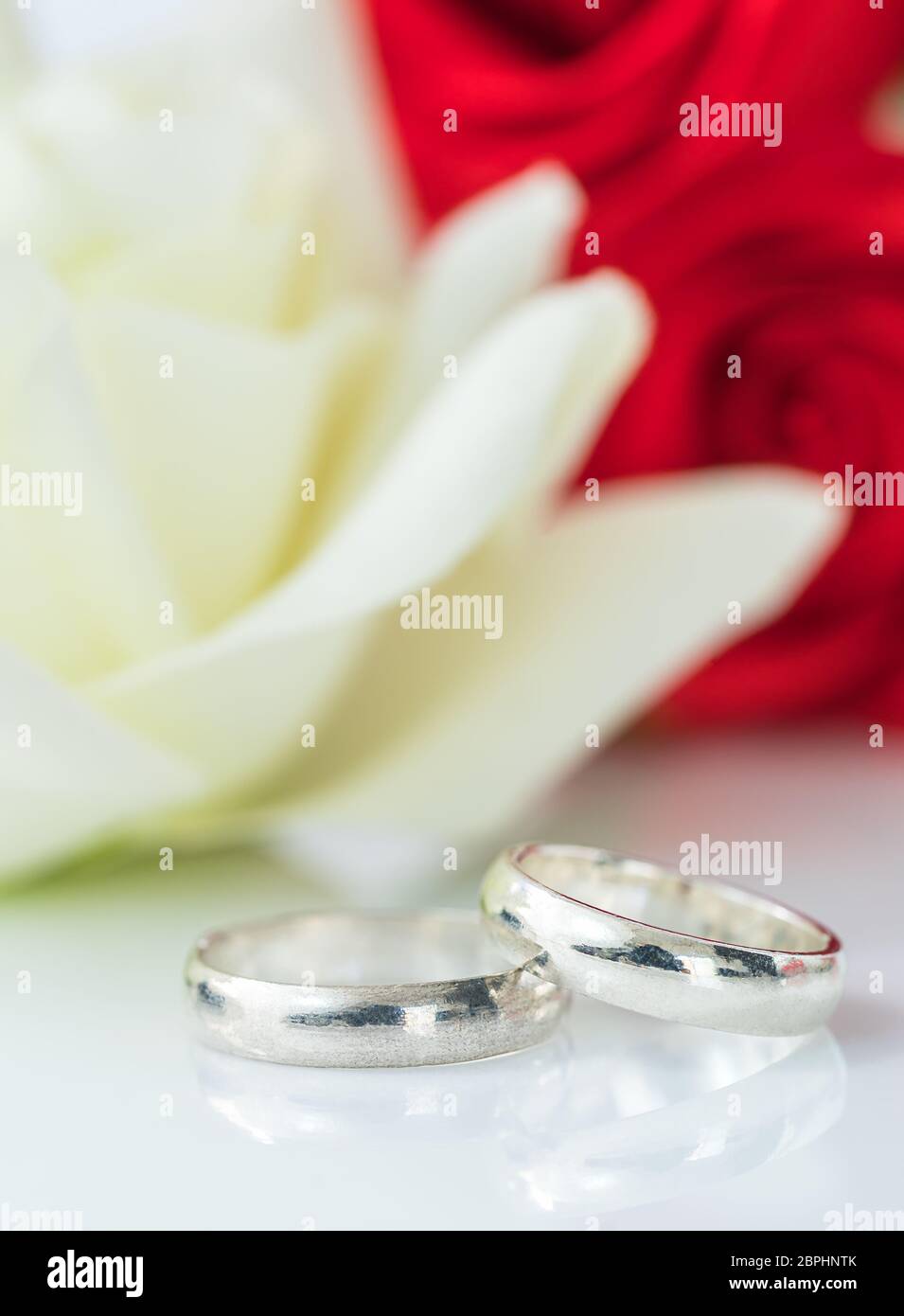 Close up red rose and wedding ring on white background, Wedding concept ...