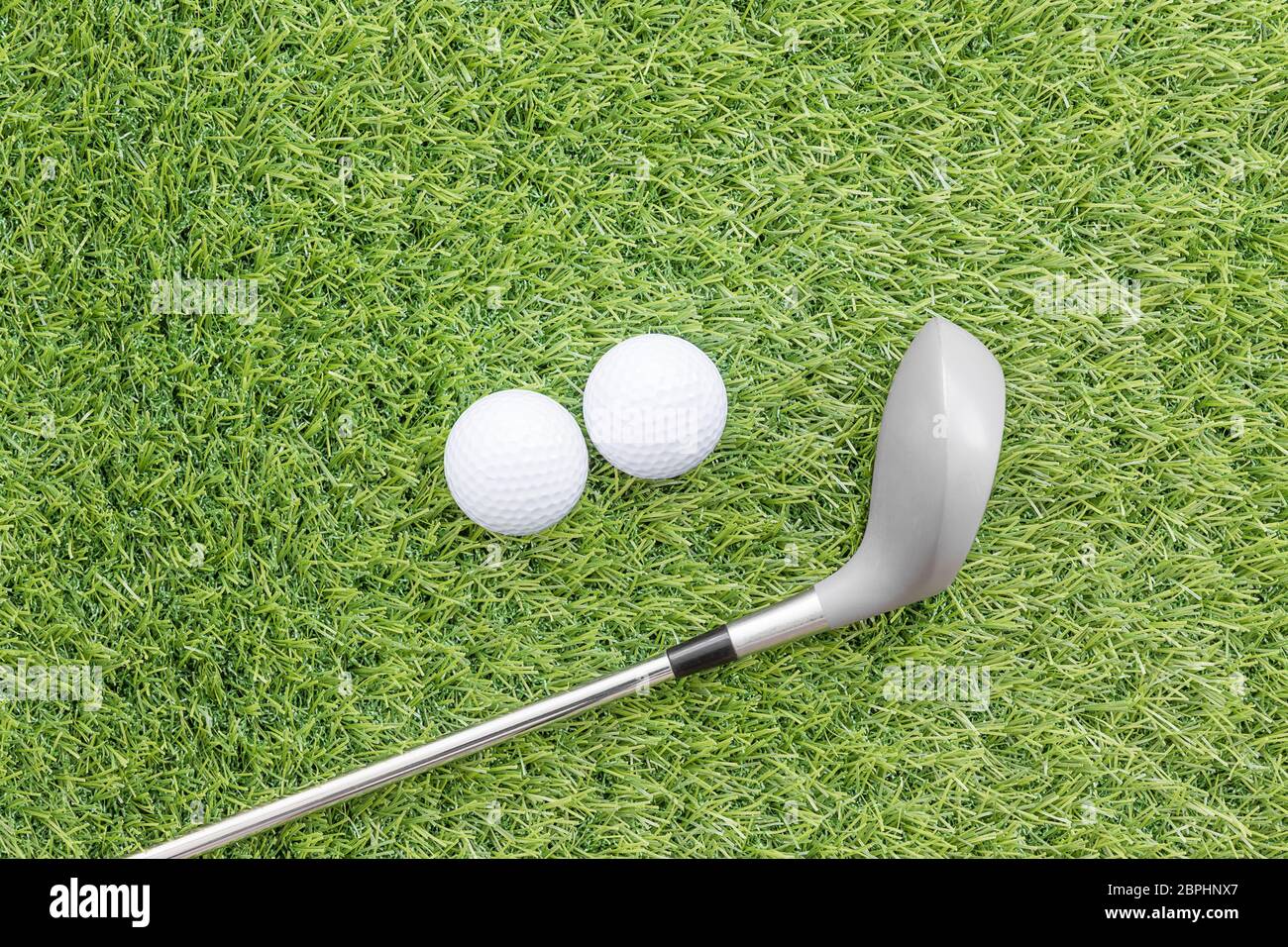 Sport objects related to golf equipment ,Golf club and ball on green ...