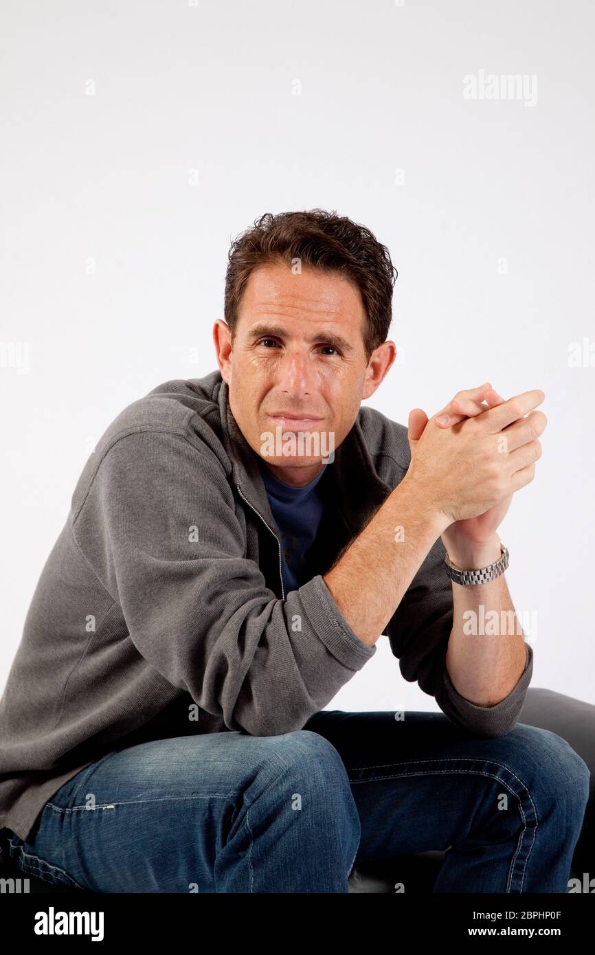 Thoughtful man sitting quietly Stock Photo - Alamy